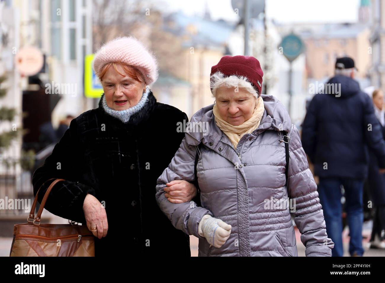 Two old women walking on a street. Life of retirees in spring city ...