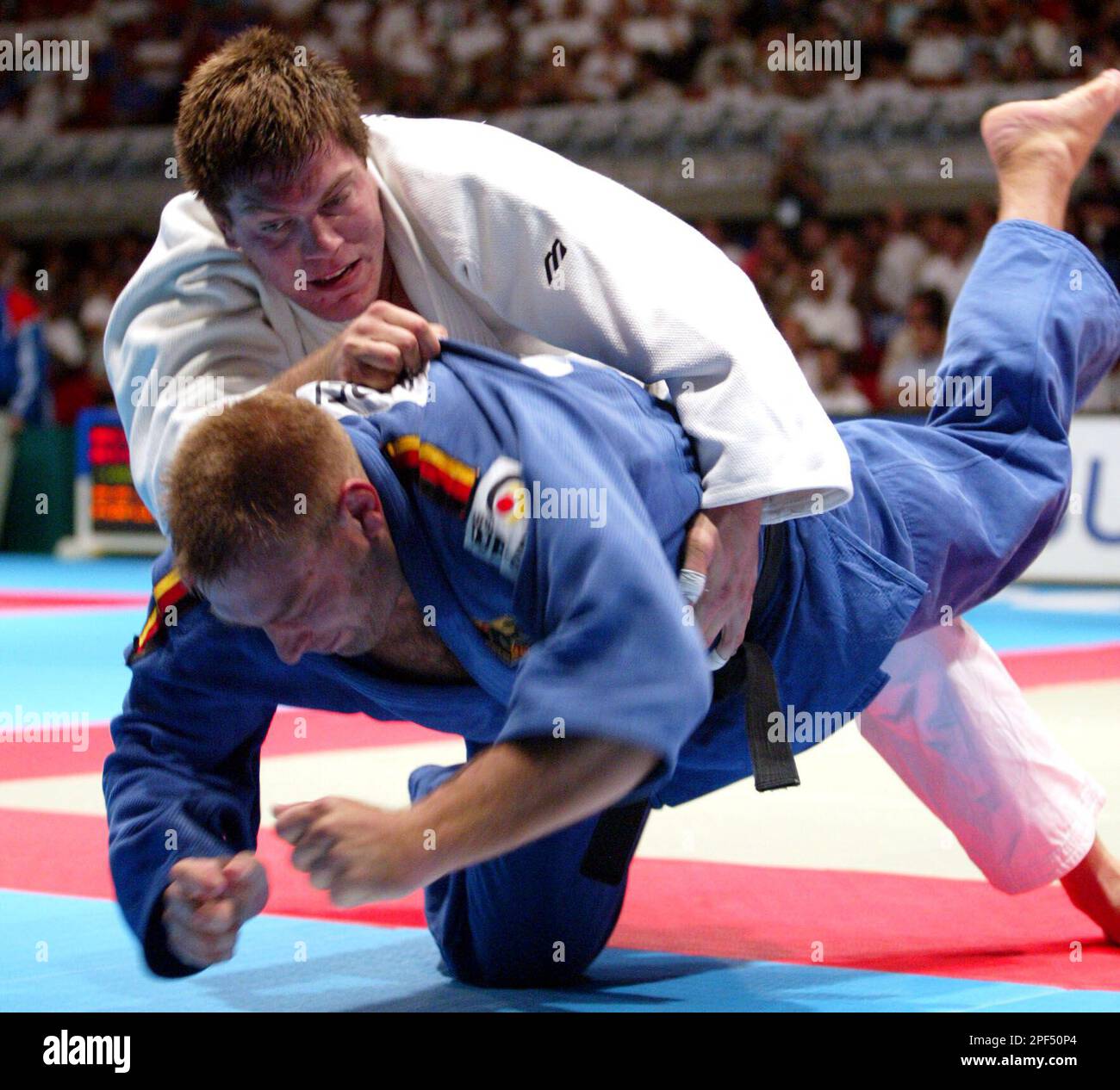 Ukraine's Yevgen Sotnikov, top, charges Germany's Frank Moeller during ...