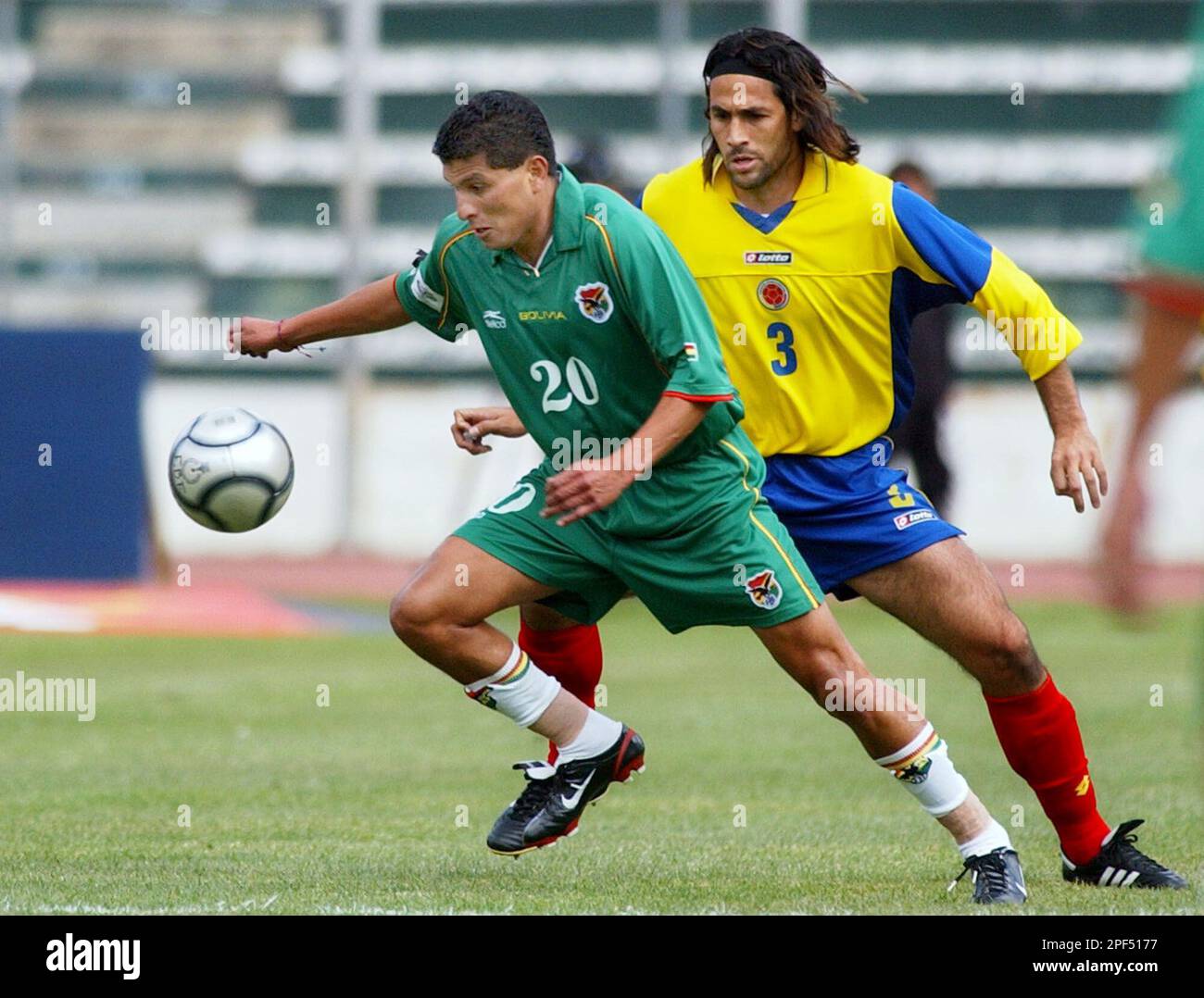 Joaquin Botero, left, of Bolivia, fights for the ball with Mario ...