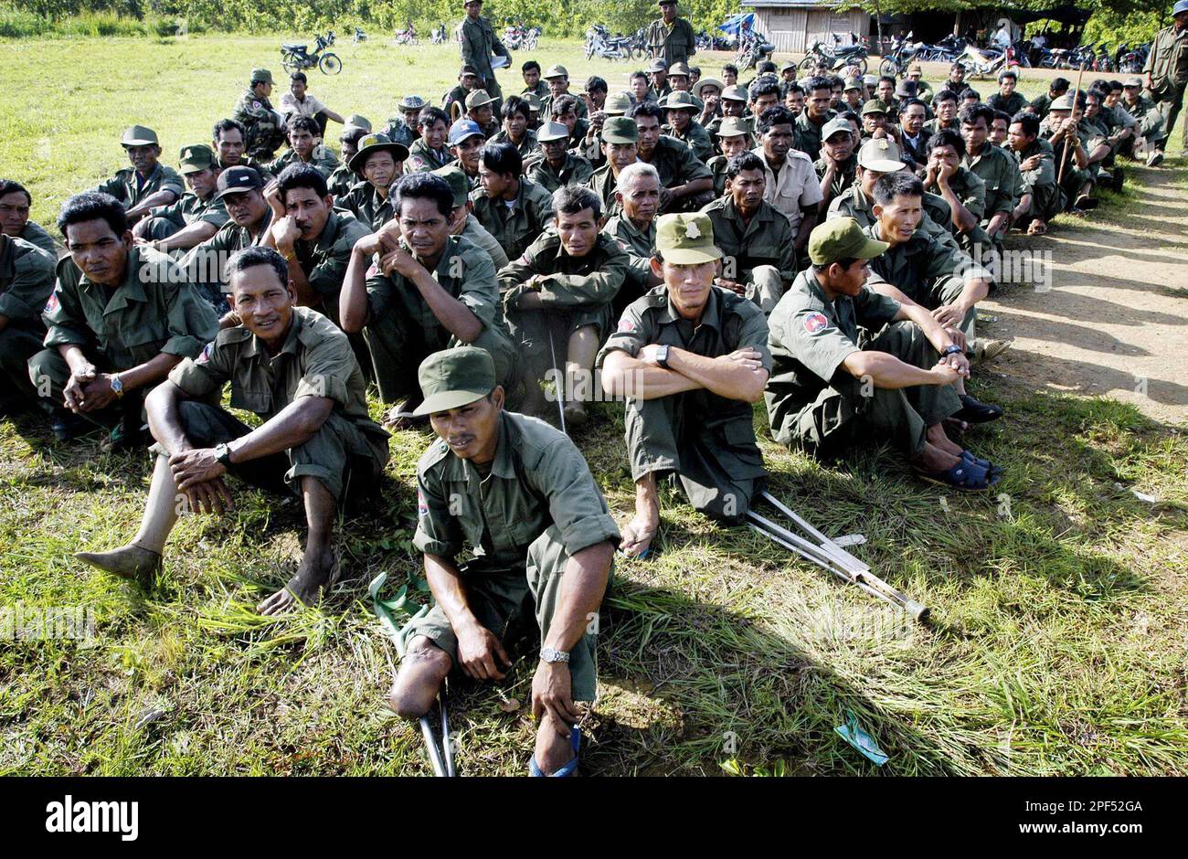Cambodian soldiers, formerly with the Khmer Rouge, muster for a meeting ...