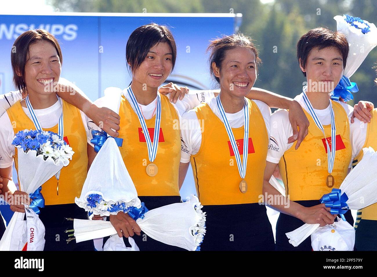 The Chinese crew celebrate on the podium after winning the women's ...