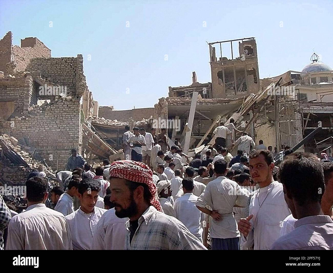 People dig through the rubble looking for bodies after a car bomb ...