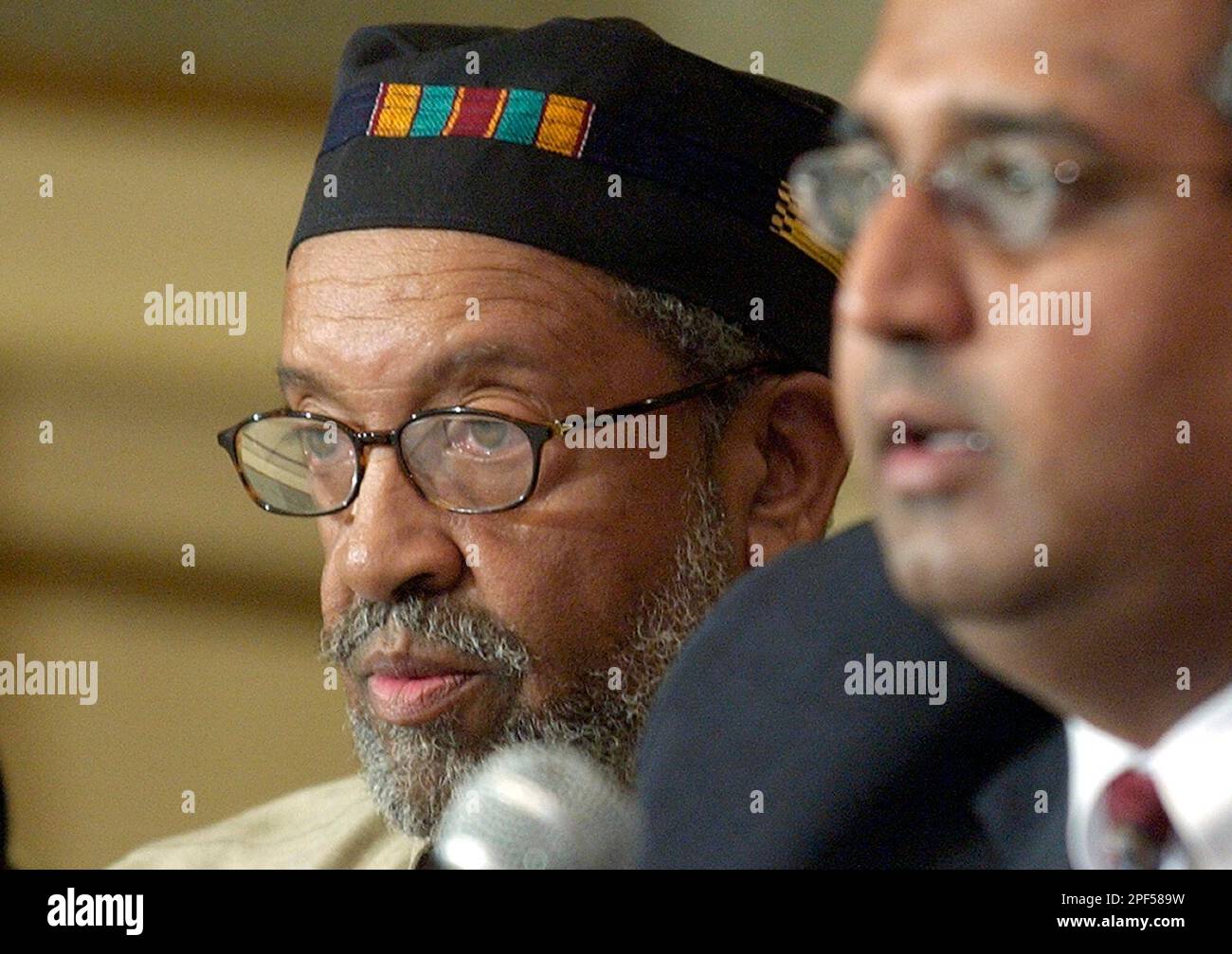 Imam W. Deen Mohammed, left, listens as Muzzammil Mahammad Hassan, right, of Bridges TV an ...