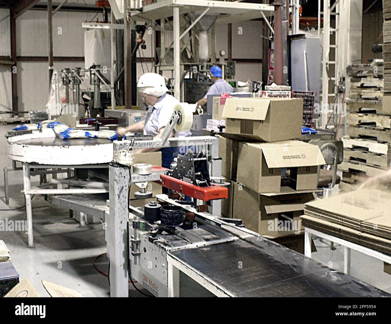 Ruth Williams works on the assembly line packing products into boxes ...
