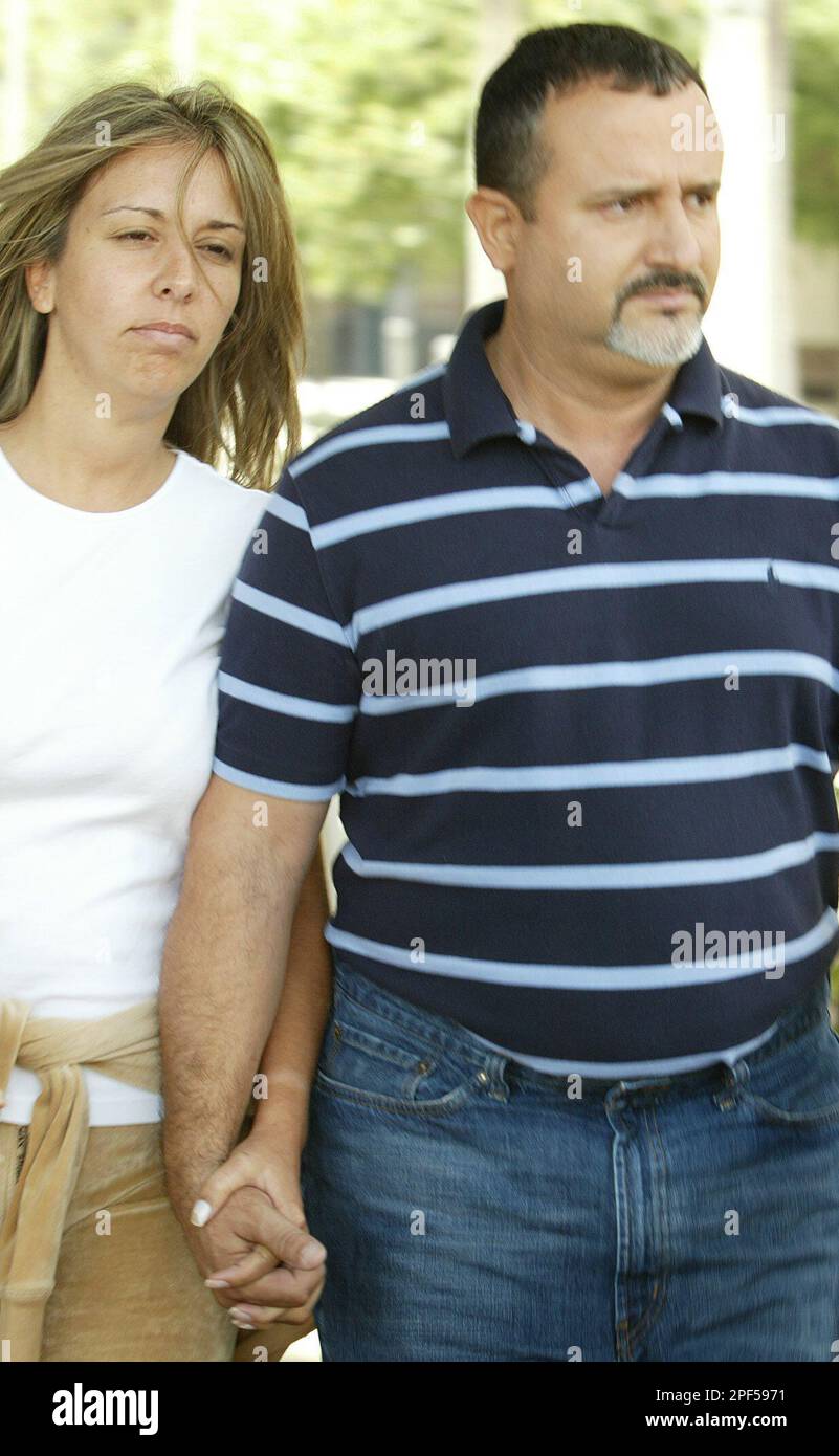 Gloria Alba, left, and her husband, Isael Alba, right, leave the ...