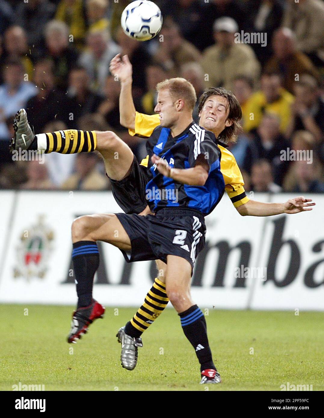Dortmund's Czech Tomas Rosicky, behind, fights for the ball with Brugge ...