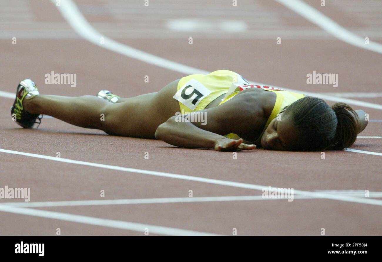 Jamaica's Brigitte Foster lies on the track after throwing herself ...