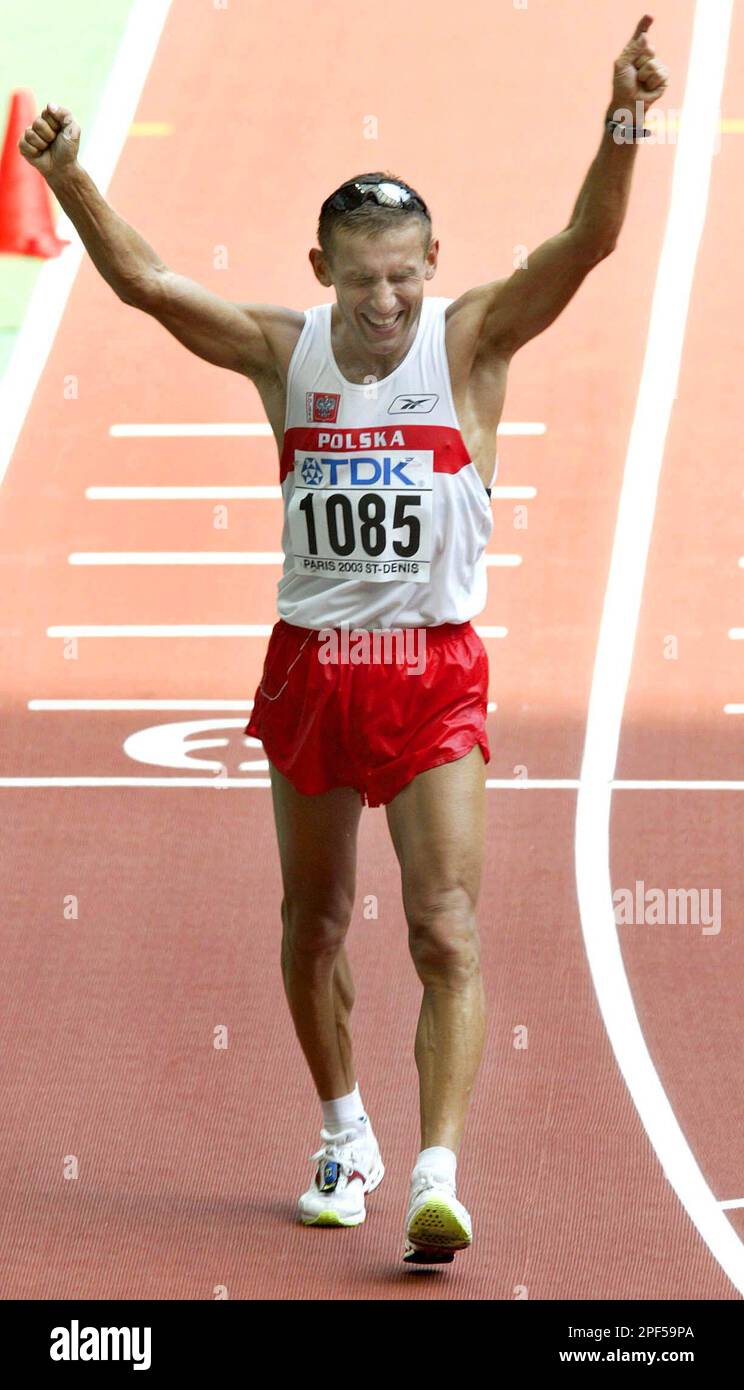 Poland's Robert Korzeniowski reacts after crossing the finish line to ...