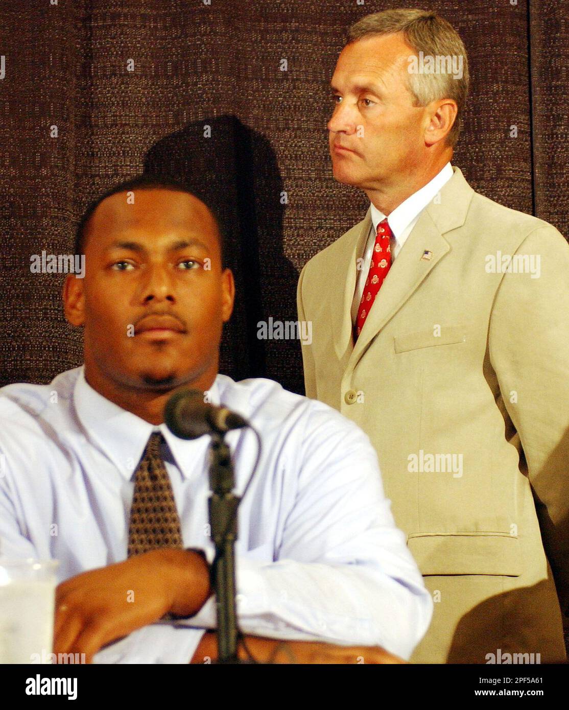 Ohio State coach Jim Tressel, right, stand behind defensive end Will ...