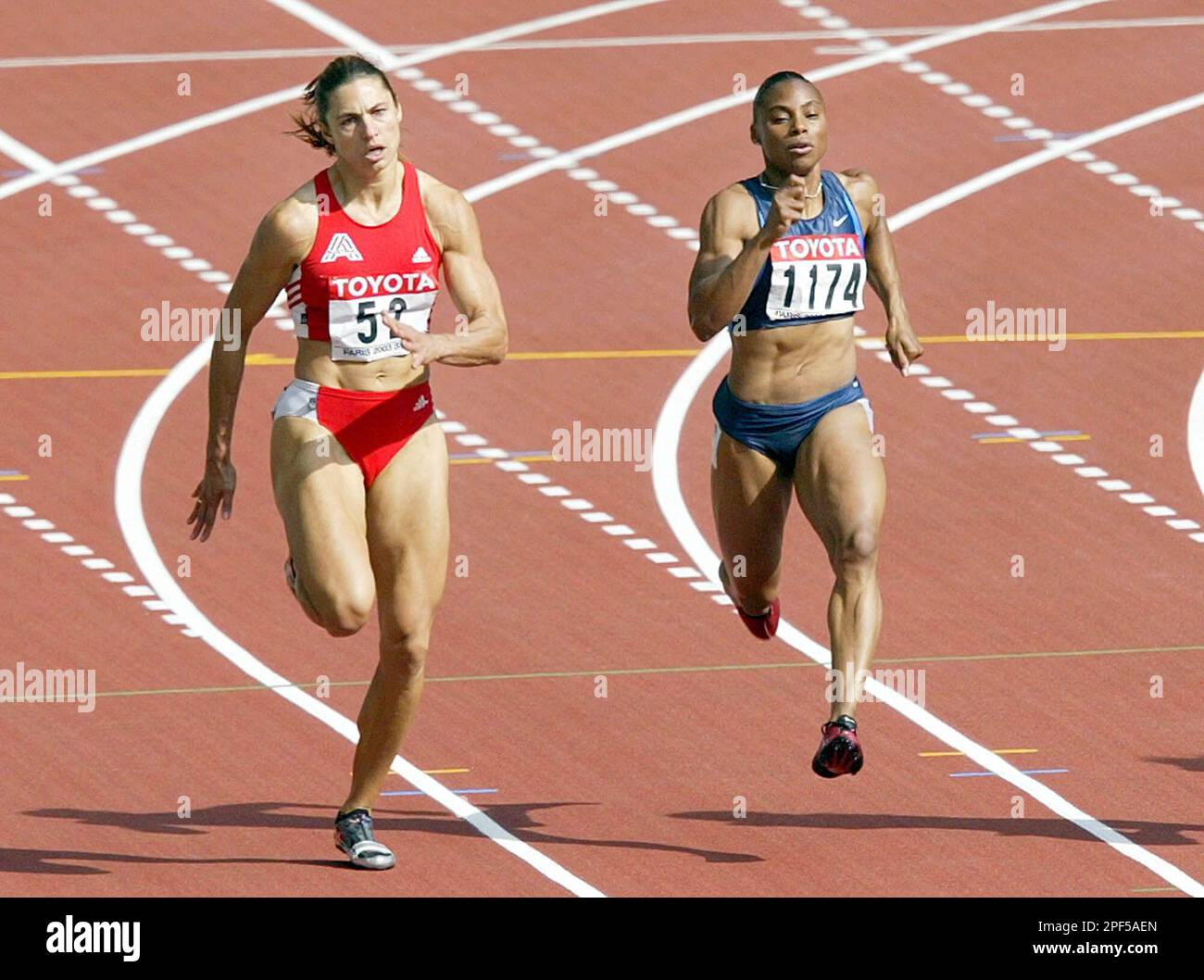 Kelli White of the United States, right, races alongside Austria's ...