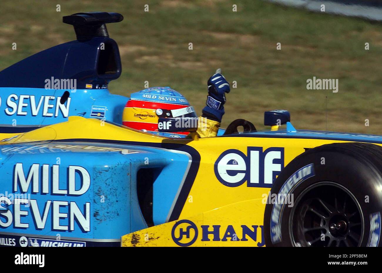 Spanish F1 driver Fernando Alonso of Renault waves from the cockpit as ...