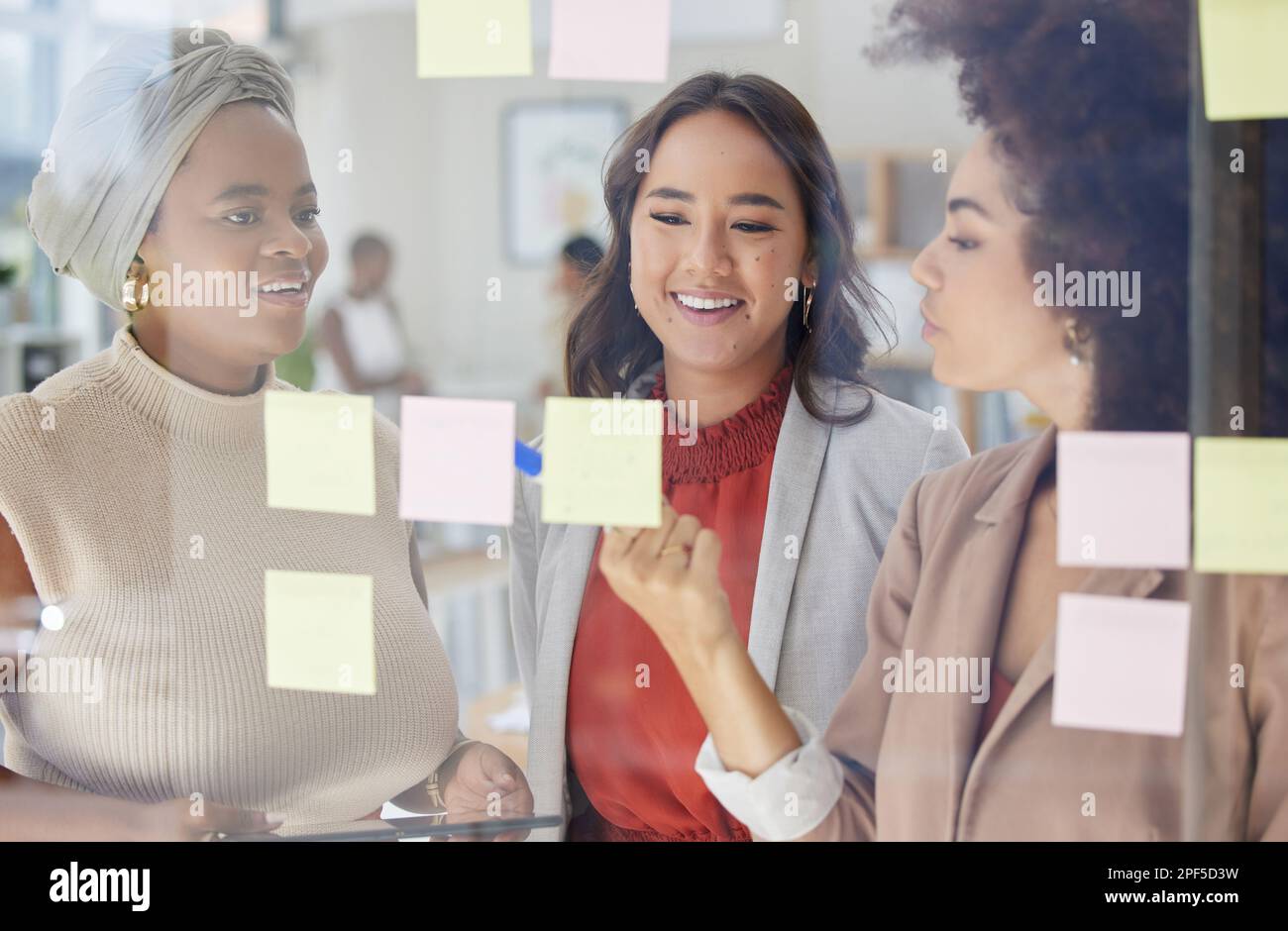 Mixed race businesswoman with afro using visual aid to brainstorm in ...