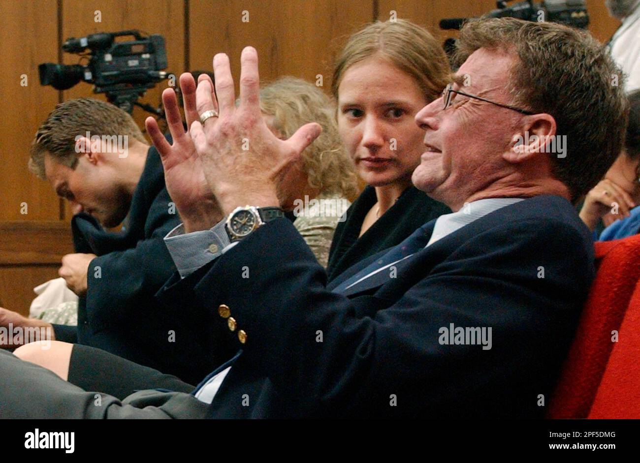 Michael Peterson, right, gestures as attempts to comfort Martha Ratliff ...