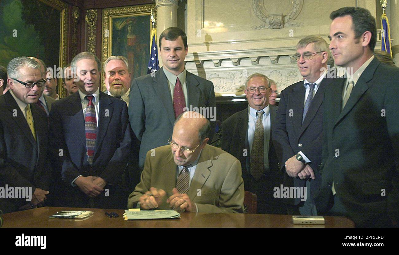 Wisconsin Gov. Jim Doyle, center, signs the new open records law bill ...