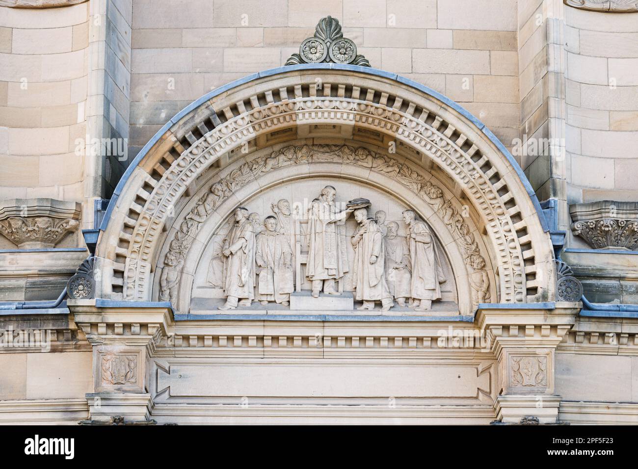 Stone carving of a graduation scene above the main entrance of McEwan ...