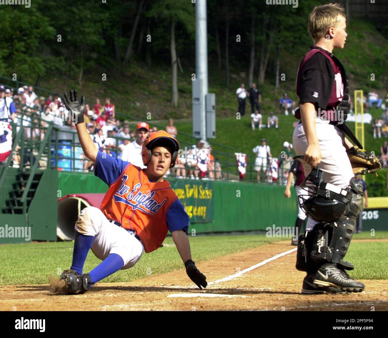 Saugus, Mass. runner David Ferreria, left, slides across the plate ...