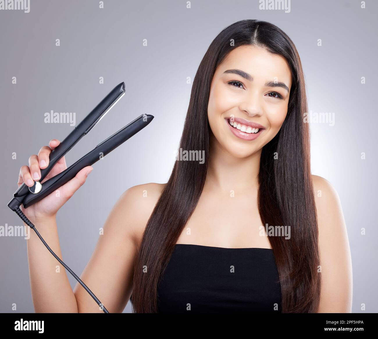 This helps me smooth out the frizzy bits. Studio portrait of an ...