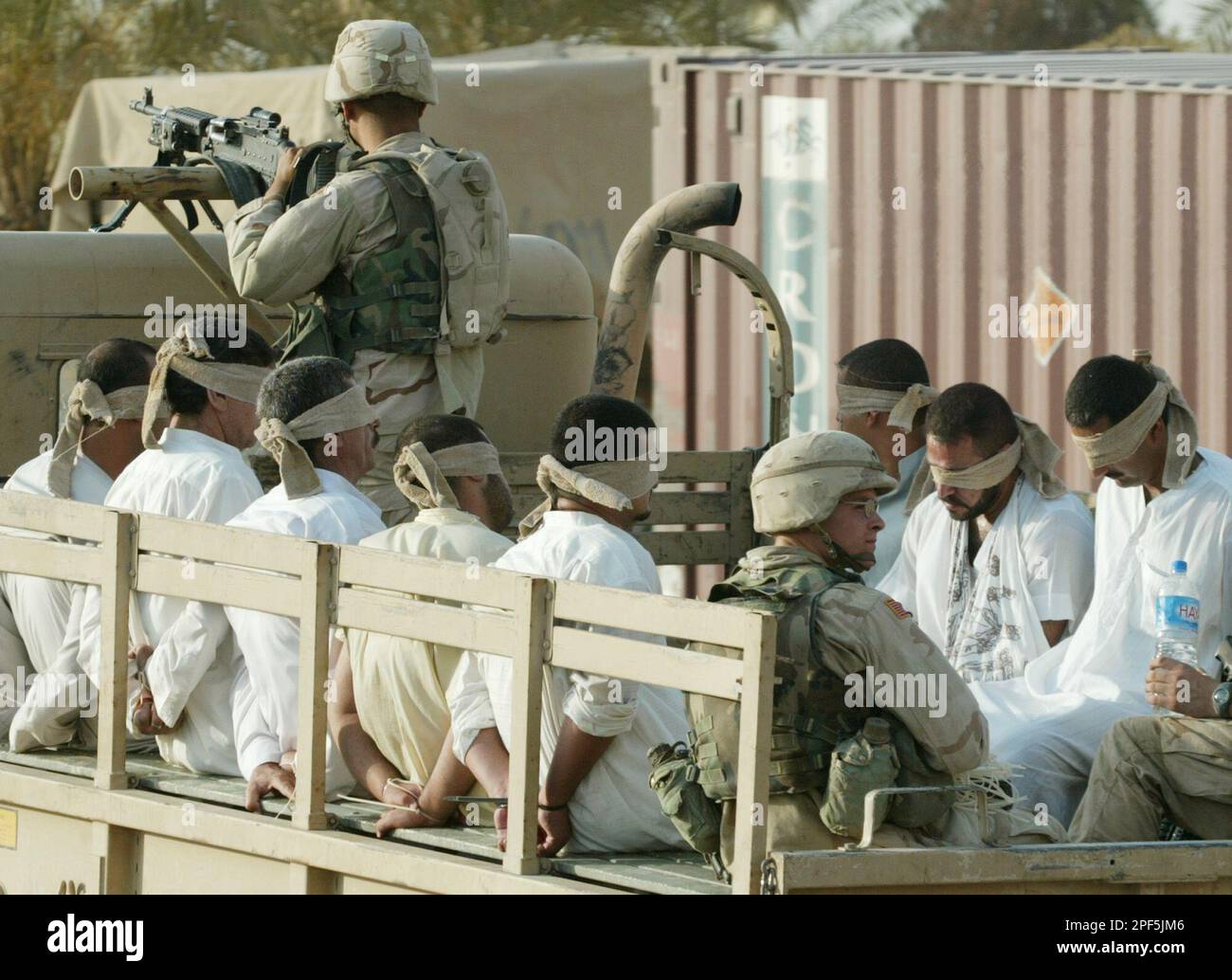 Iraqi detainees captured by U.S. soldiers are driven for a U.S. army ...