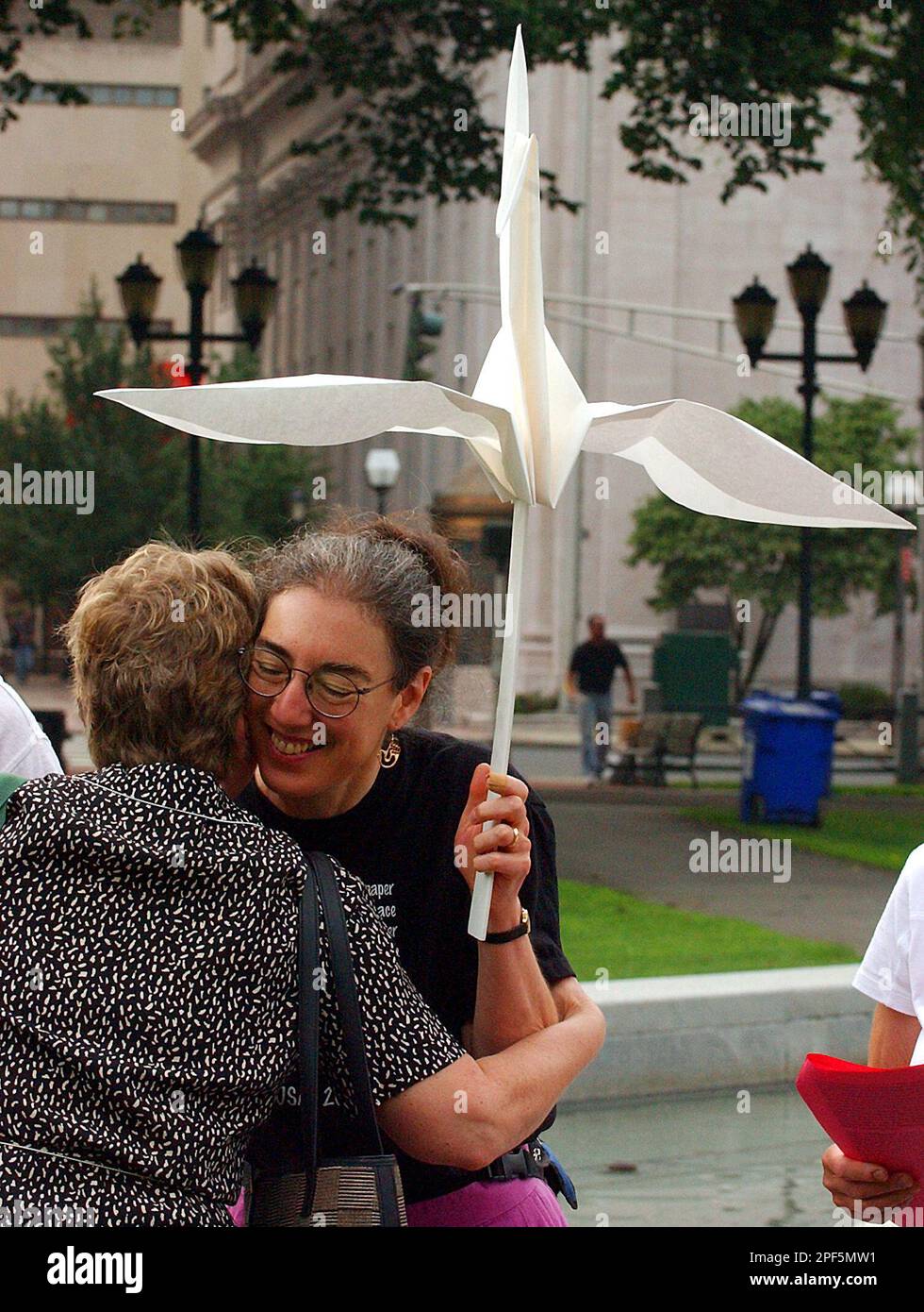 Susan Klein is hugged by a passerby as she participated in a vigil on ...