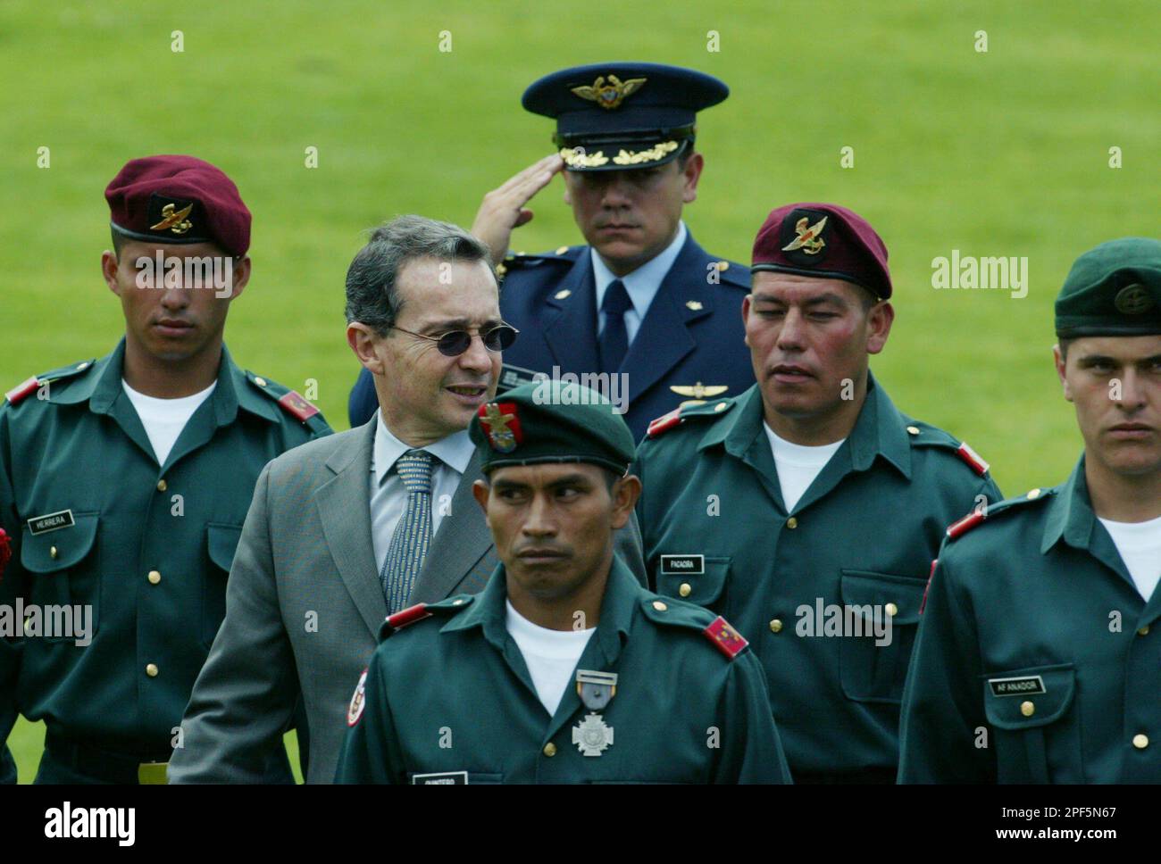 Colombia's President Alvaro Uribe walks among soldiers after honoring ...