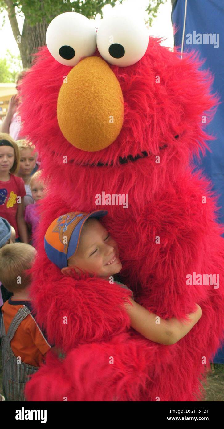 Noel Utecht, 4, of Redfield gives Elmo a big hug Tuesday, July 29, 2003 ...