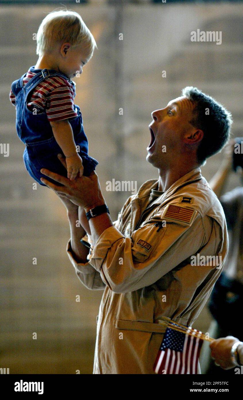David of the 934 Airlift Wing holds his 17-month-old son Carter before ...