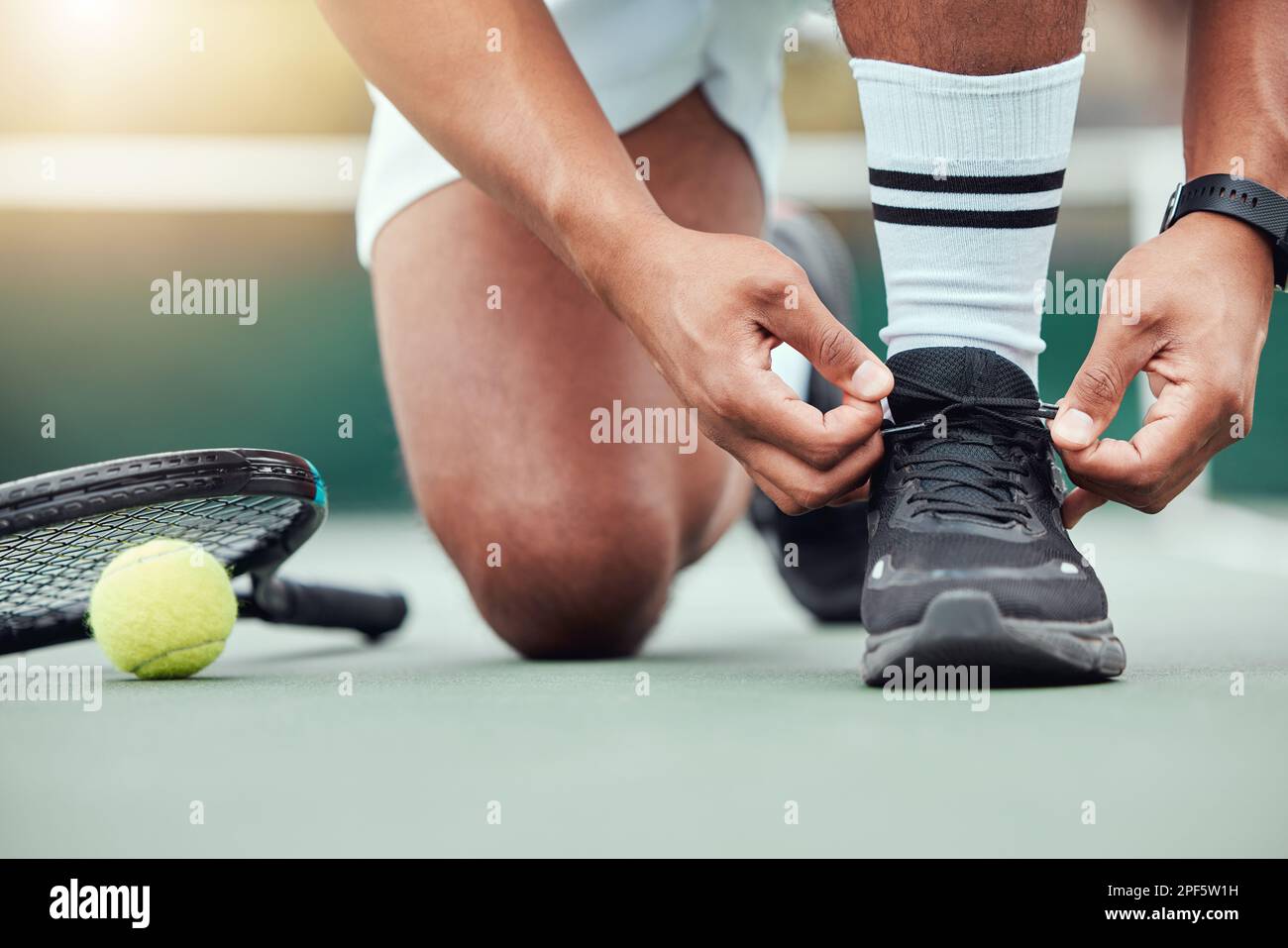 Closeup of unknown indian tennis player getting ready and tying ...