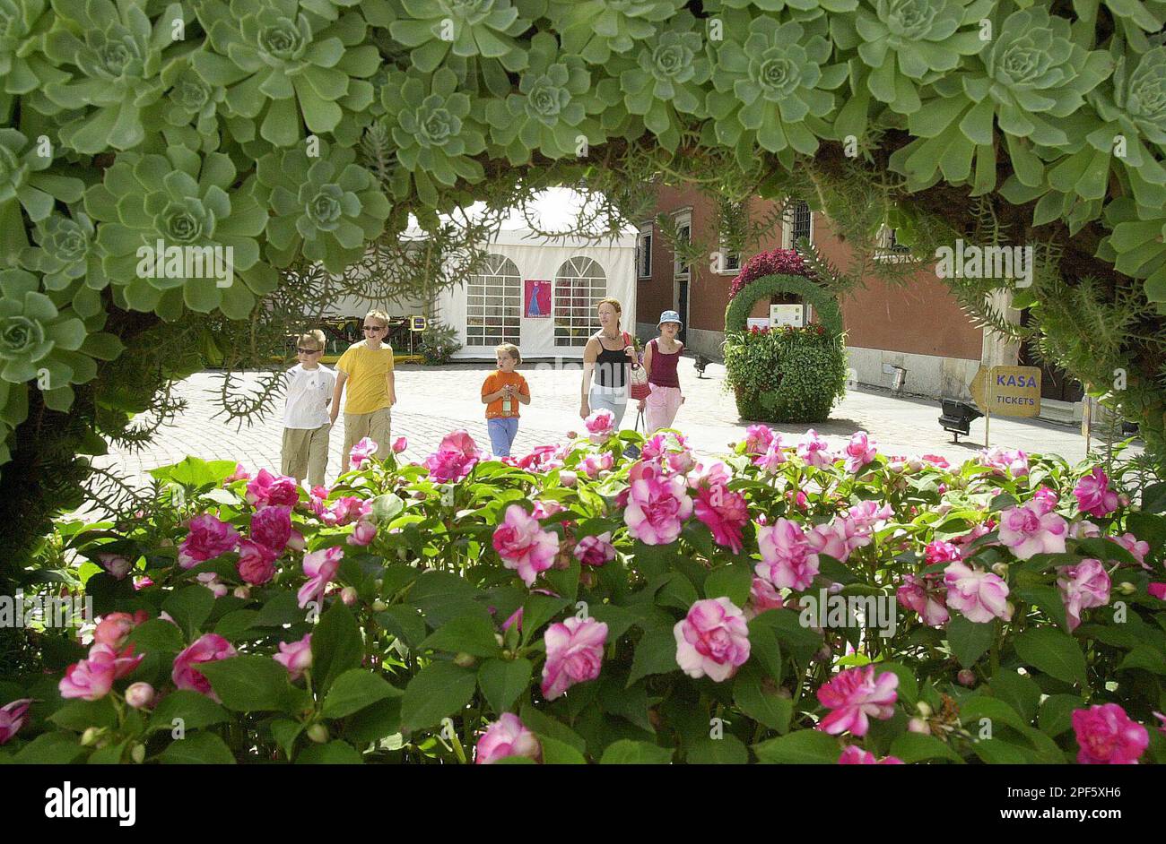 Visitors enjoy floral arrangements, some over 2.5 meters (7.5 feet ...