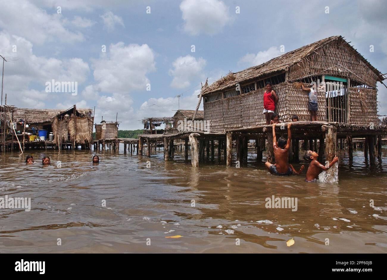 Indigenous Wayu swim around their homes at Sinamaica lake in western ...