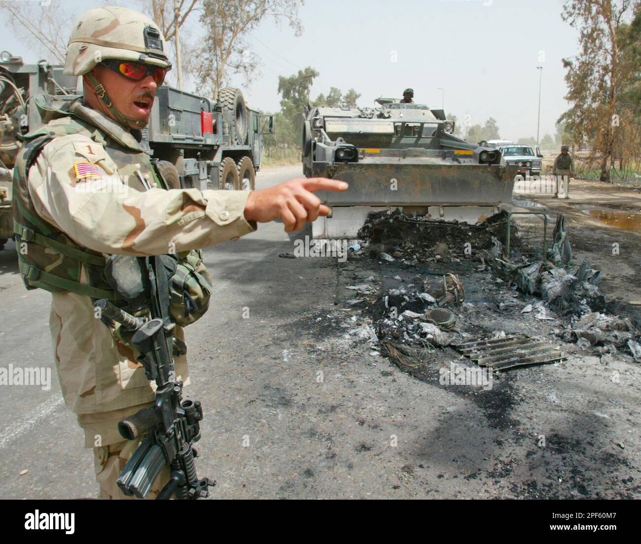 A U.S. soldier from the 1st Armored Division directs clean-up ...