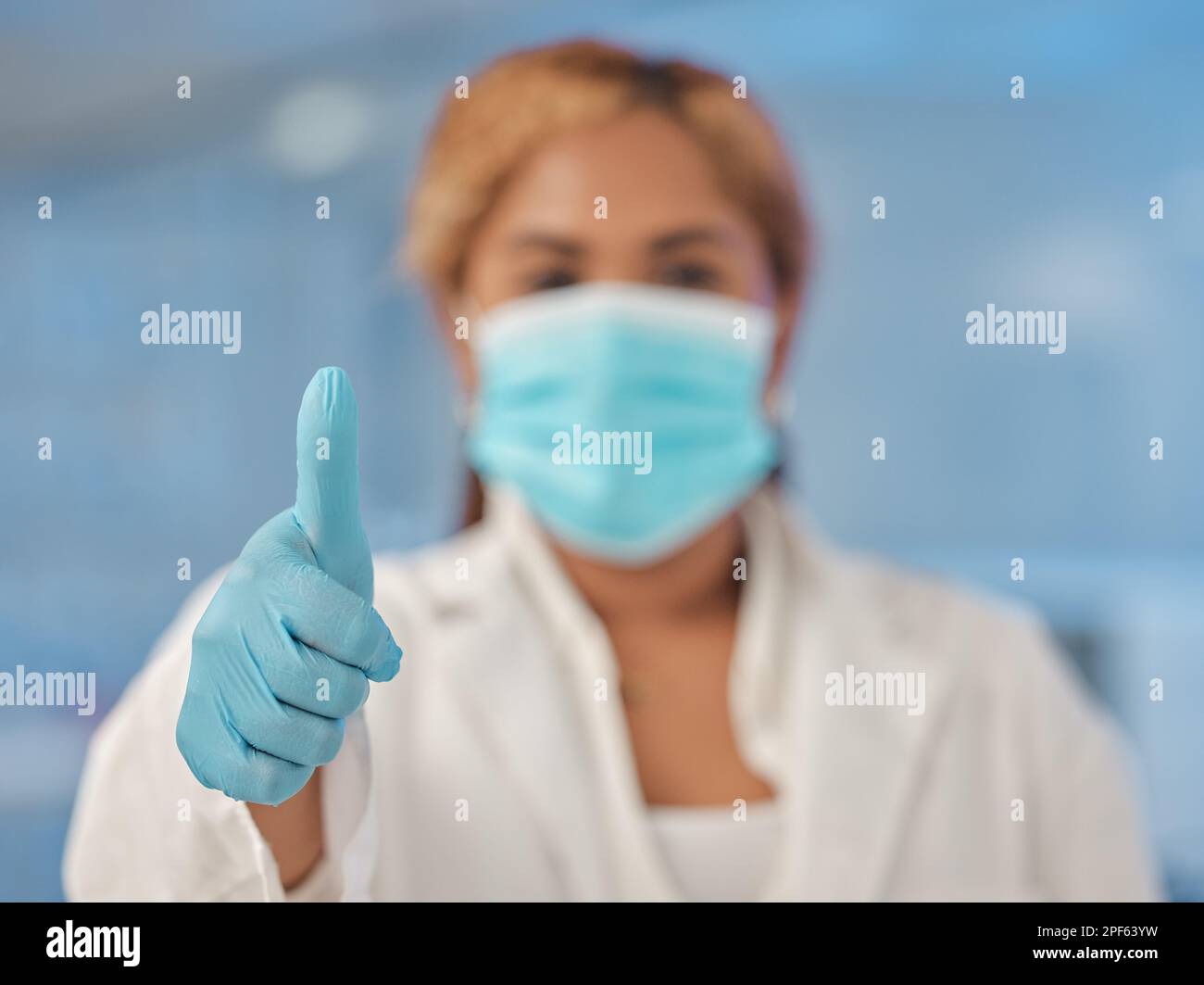 A positive attitude goes a long way. a lab tech giving the thumbs up ...
