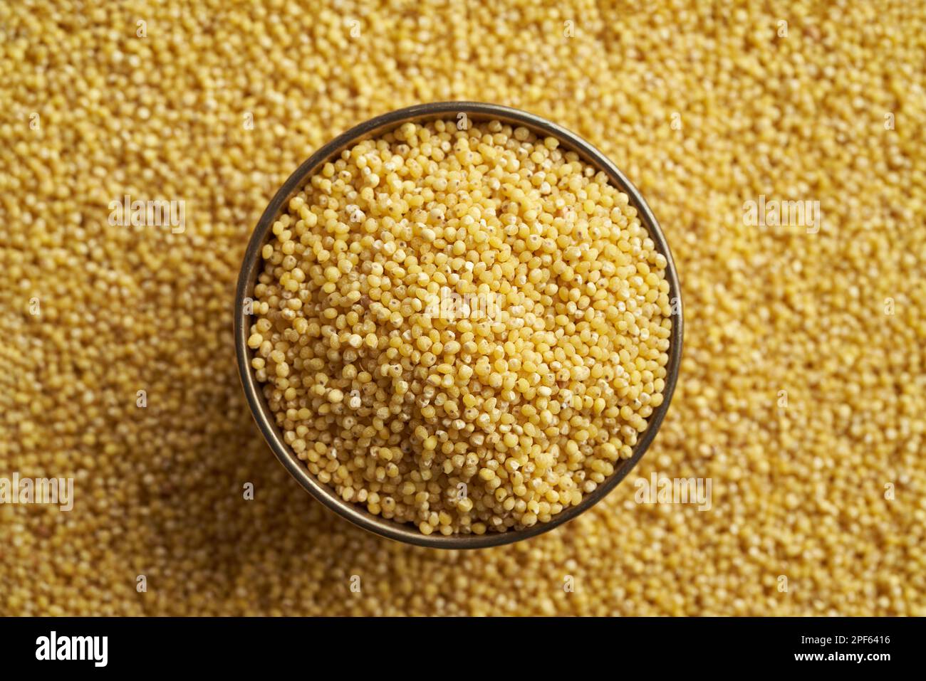 Dry peeled millet in a bowl Stock Photo - Alamy