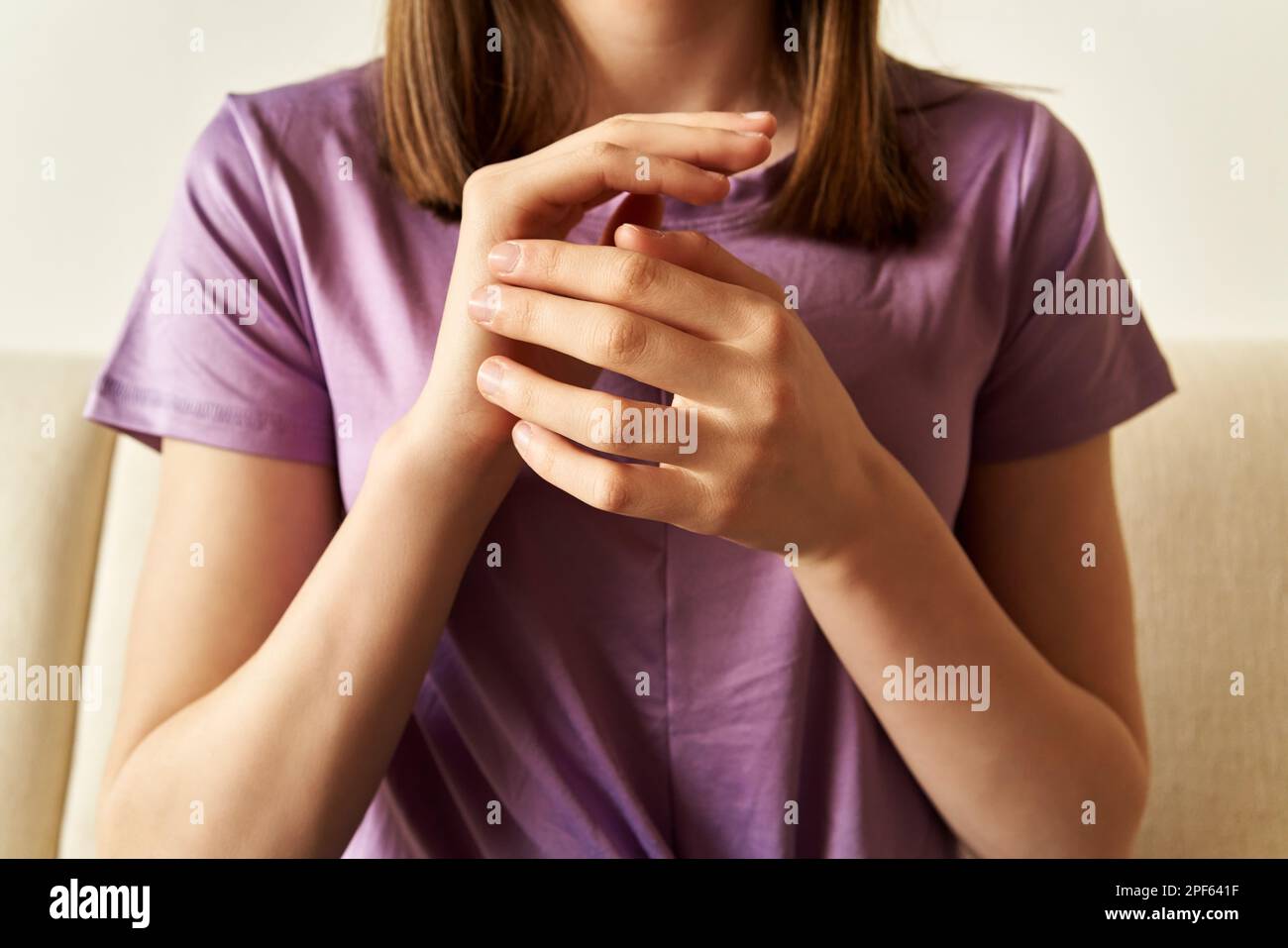 Young teenage girl practicing emotional freedom technique or EFT ...
