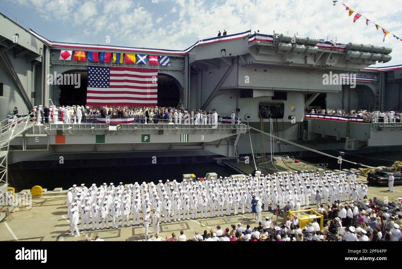 Crewmembers stand in formation on the pier as they wait for the ...