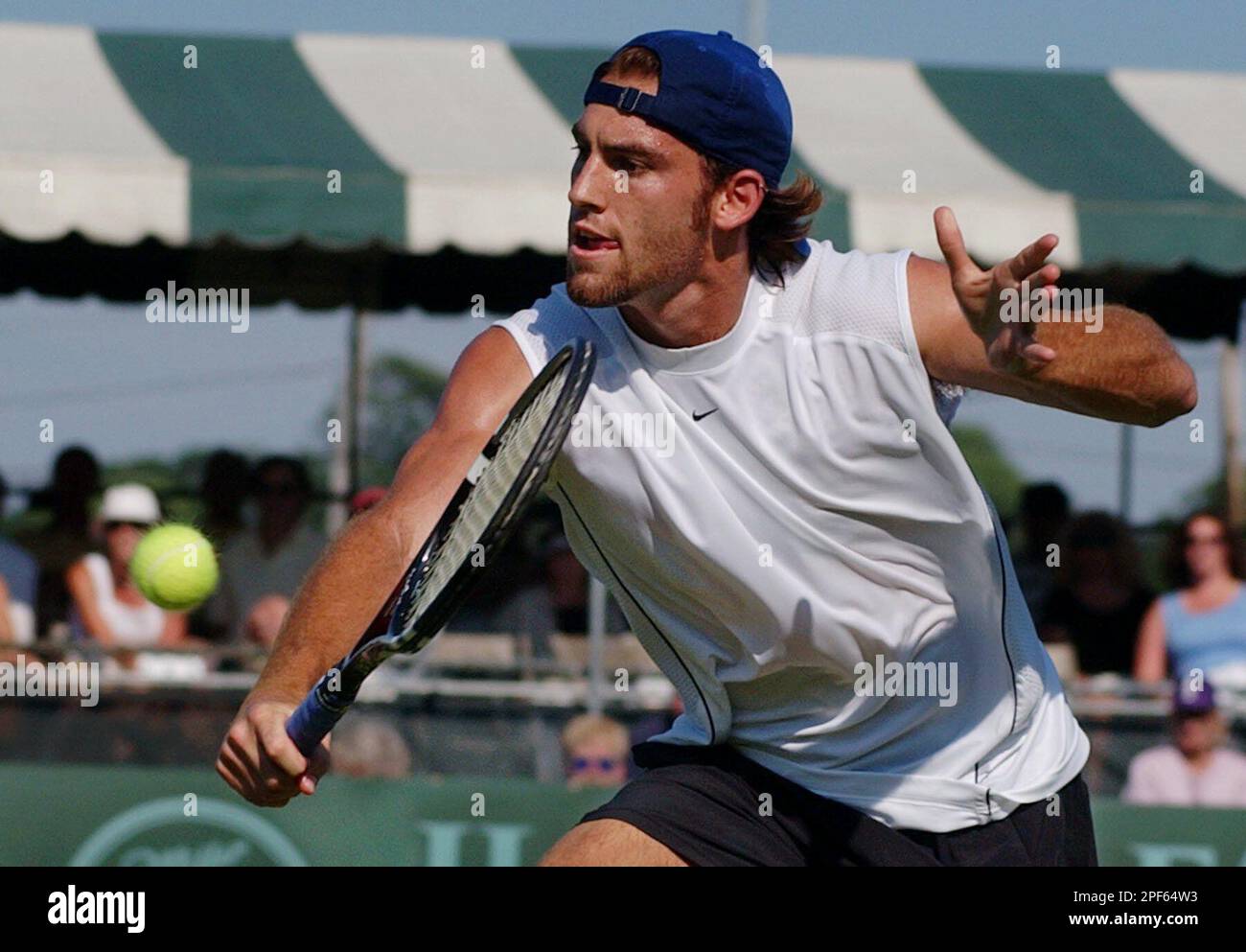 Robby Ginepri returns a shot to Gregory Carraz, of France, at the Hall ...