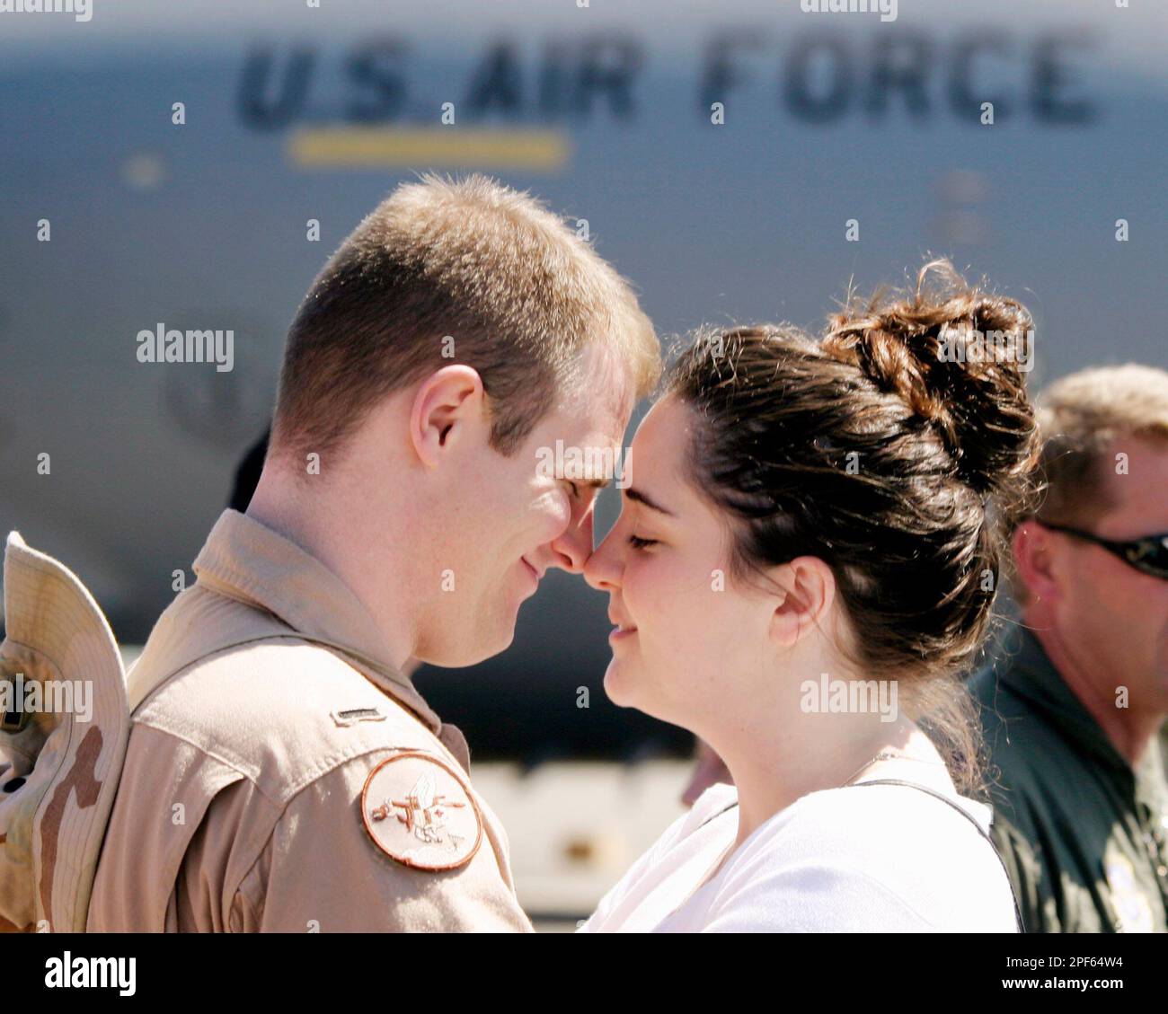 Katrina Townsley, right, greets her fiance Lt. Steven Niewiarowski, a ...