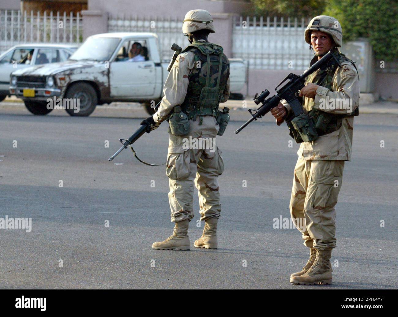 US soldiers guard the scene where an improvised explosive device (IED ...