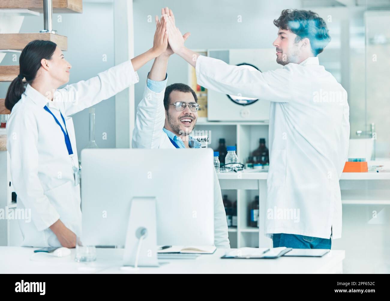 We finally solved it. a group of young scientists giving each other a ... We finally solved it. a group of young scientists giving each other a ...