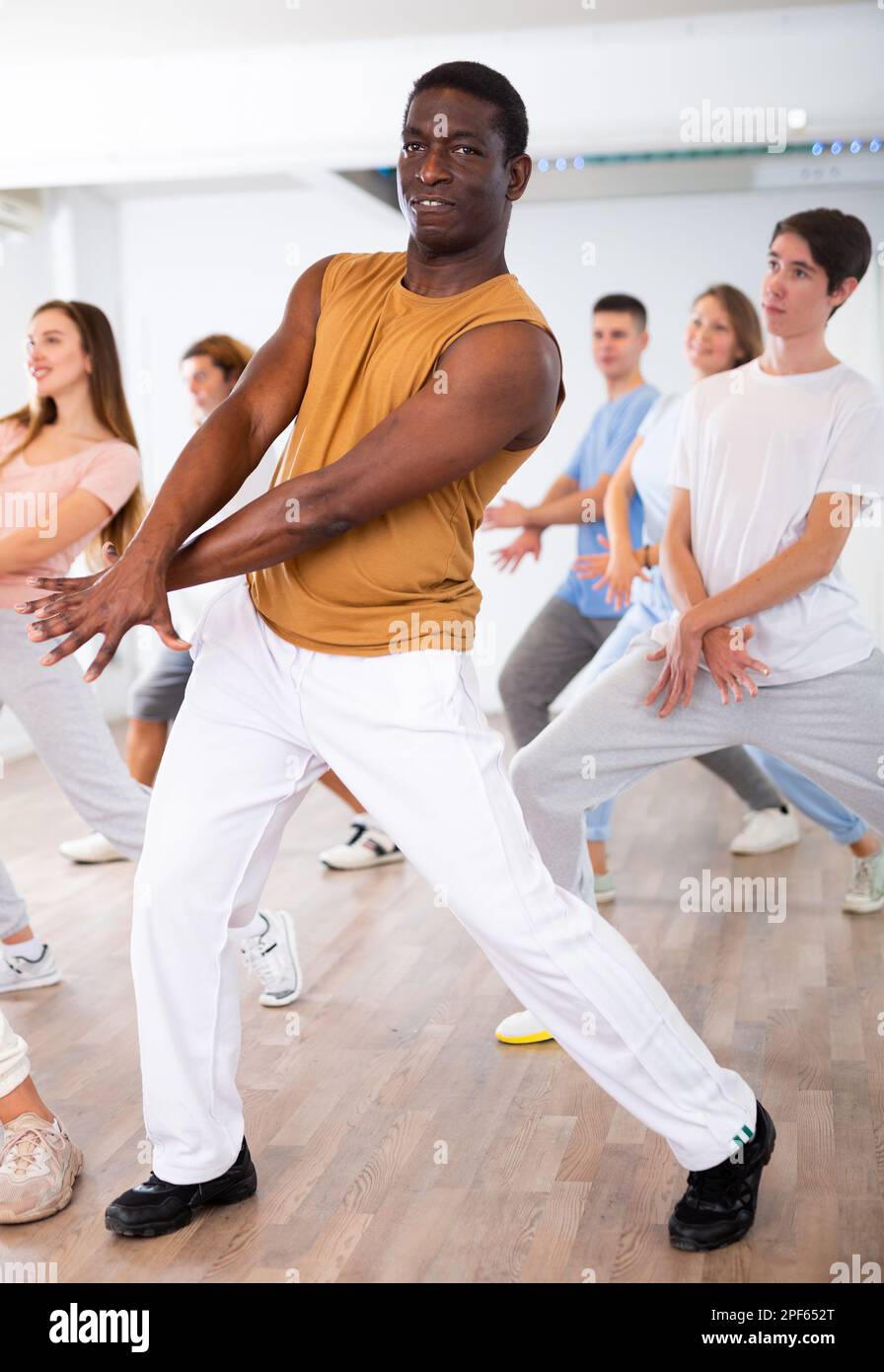 Group of different people rehearsing dance in dance studio Stock Photo ...