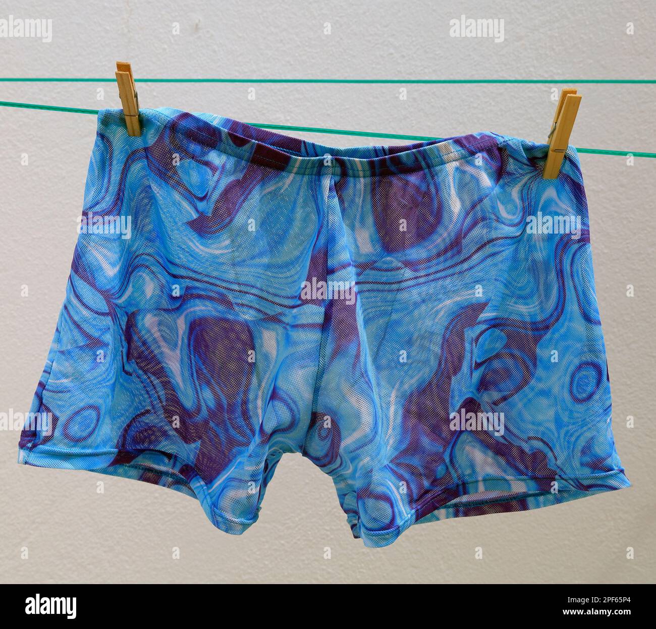 Swimming trunks on a washing line. Tan-through material. cym Stock ...