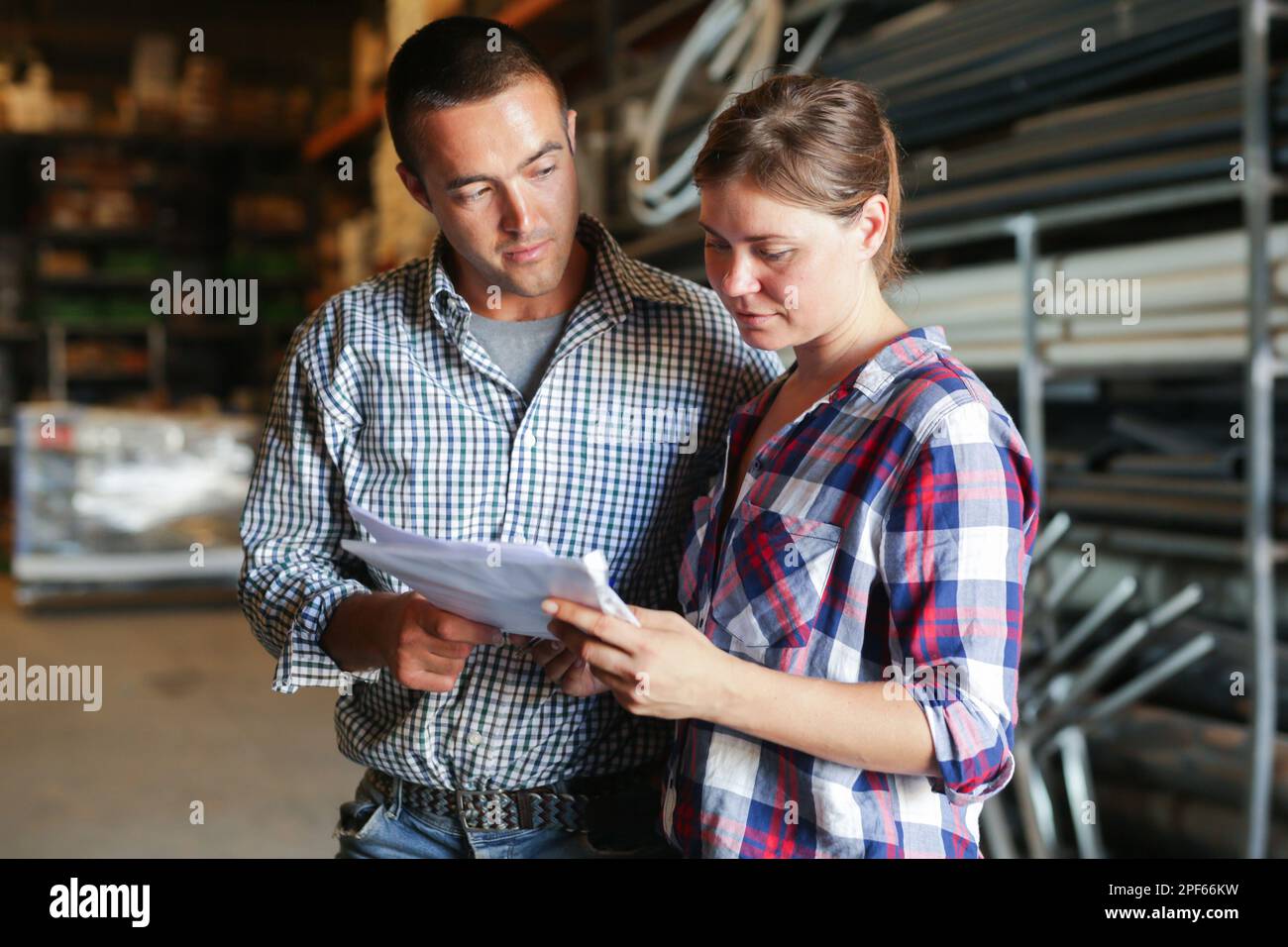 Manager and employee together checking availability of goods in ...