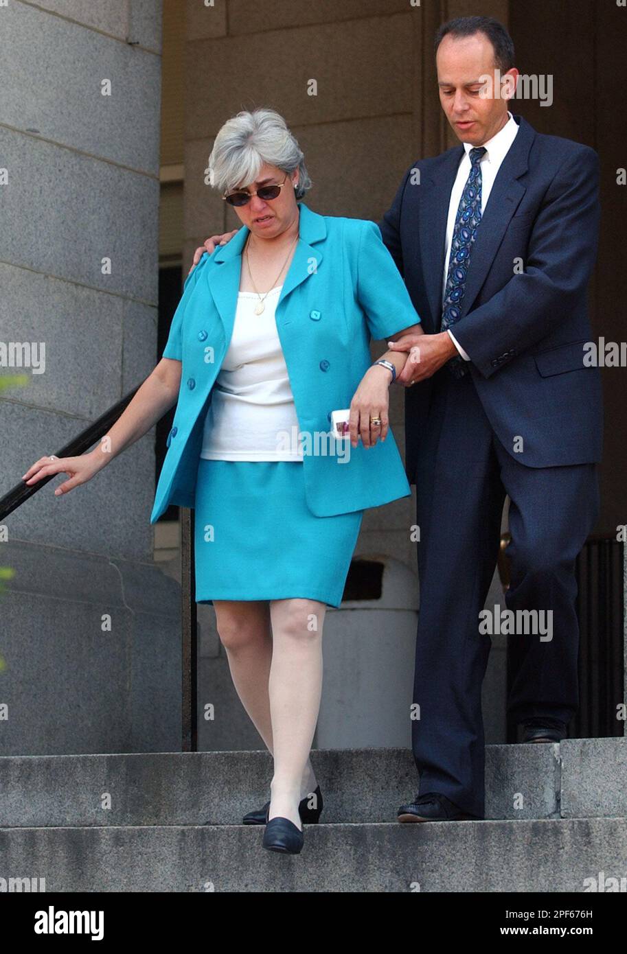 Ron Witman, right, helps his wife Sue Witman walk down the steps of the ...