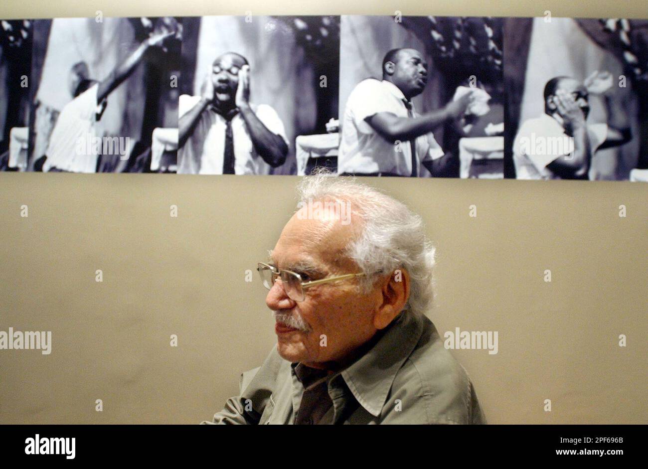 A series of his pictures surrounds Milton Rogovin at the opening of his ...