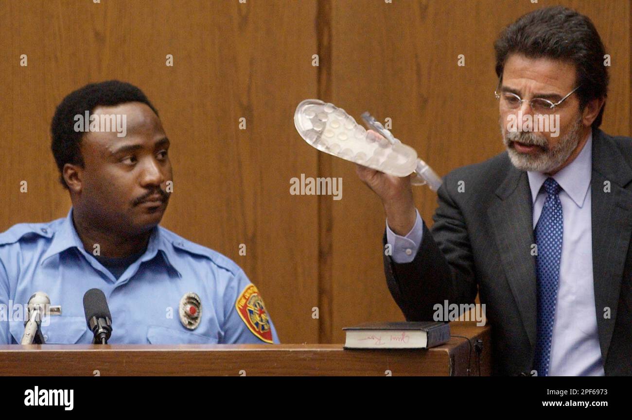 Defense attorney David Rudolf, right, asks Durham firefighter Jayson ...