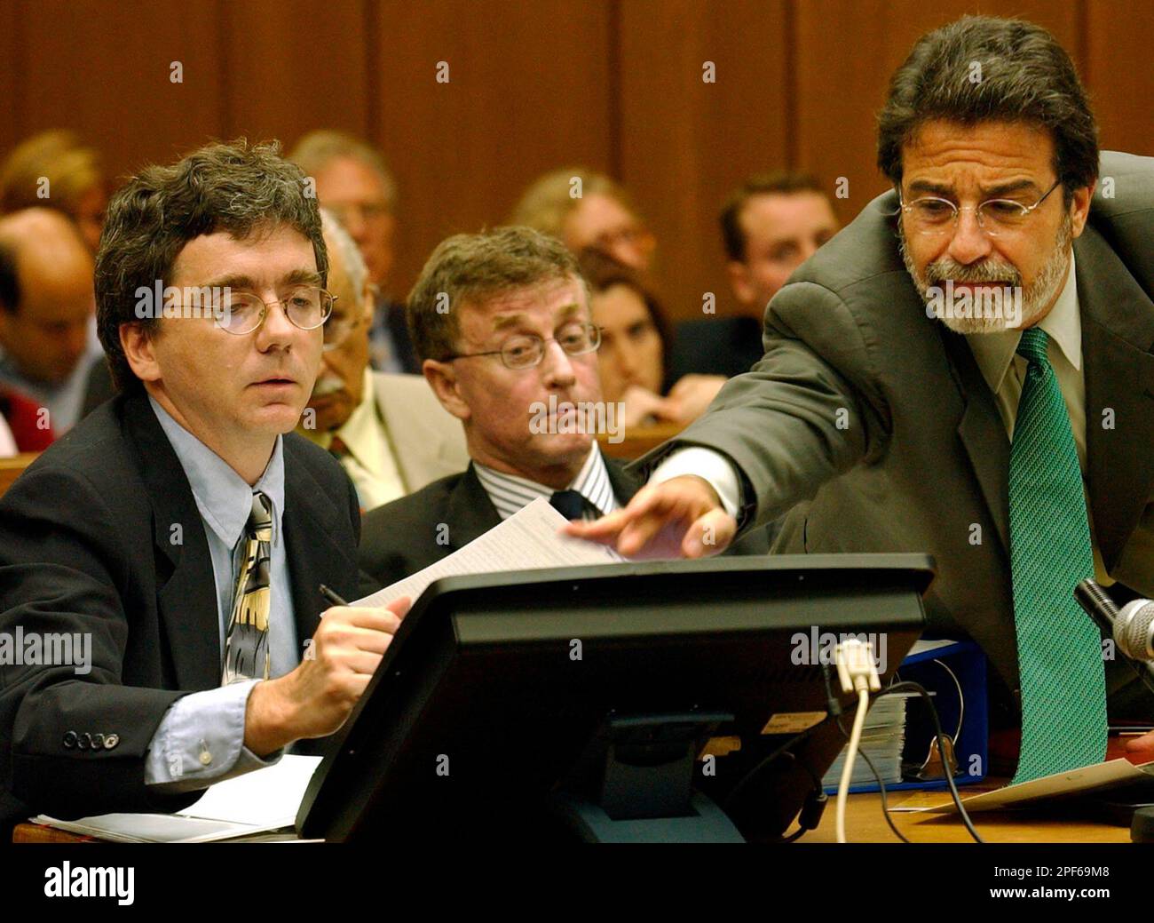 Lead defense attorney David Rudolf, right, leans across Michael ...