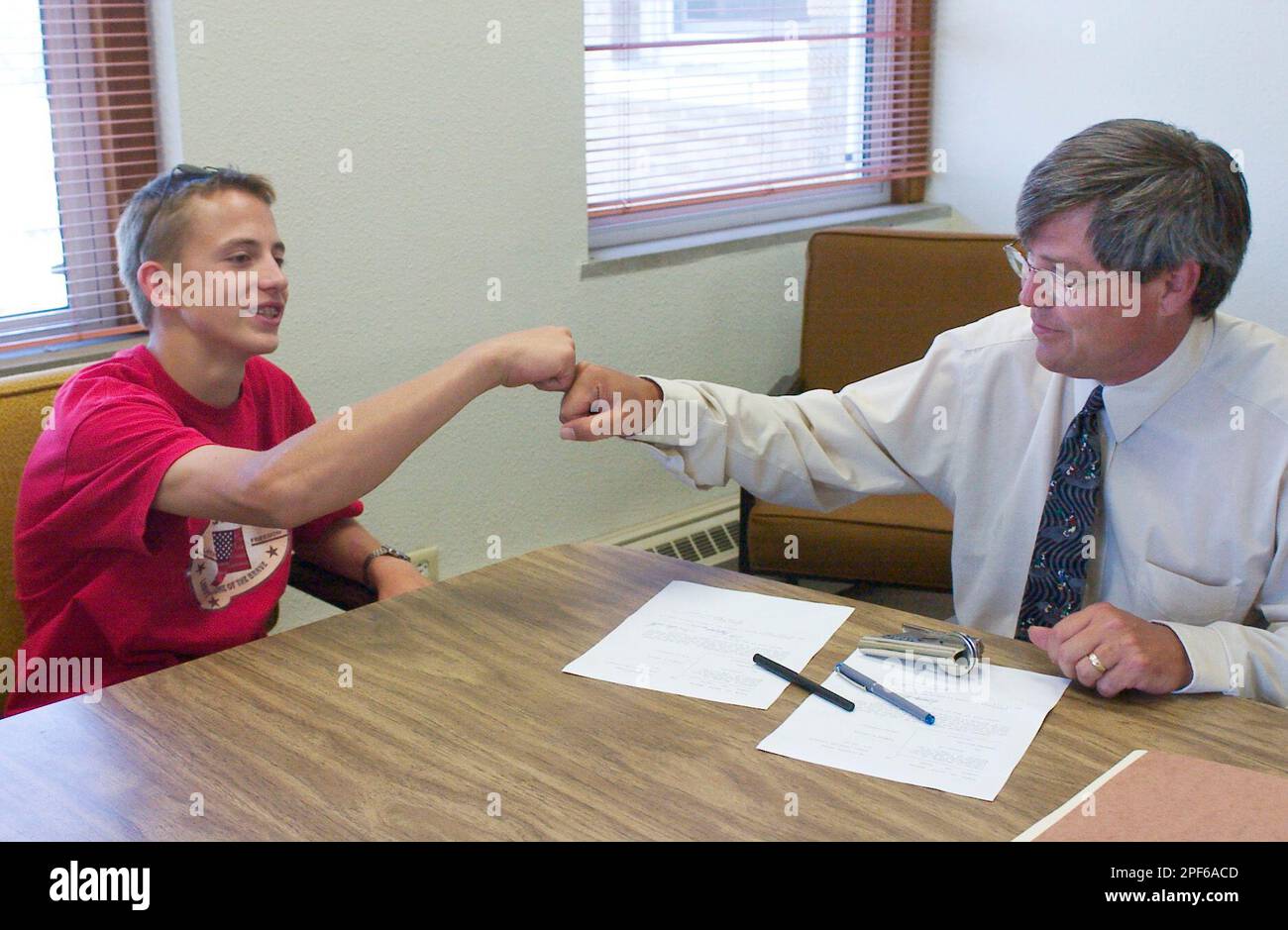 Timmie Meldrum, 14, left, exchanges greetings with his lawyer, Steve ...