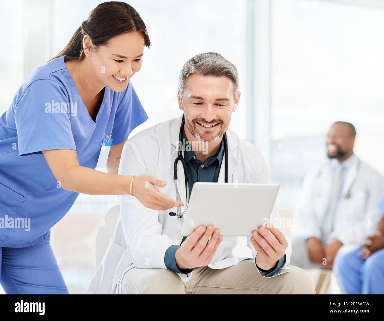 Discussing how to make the world a better place. two doctors using a ...