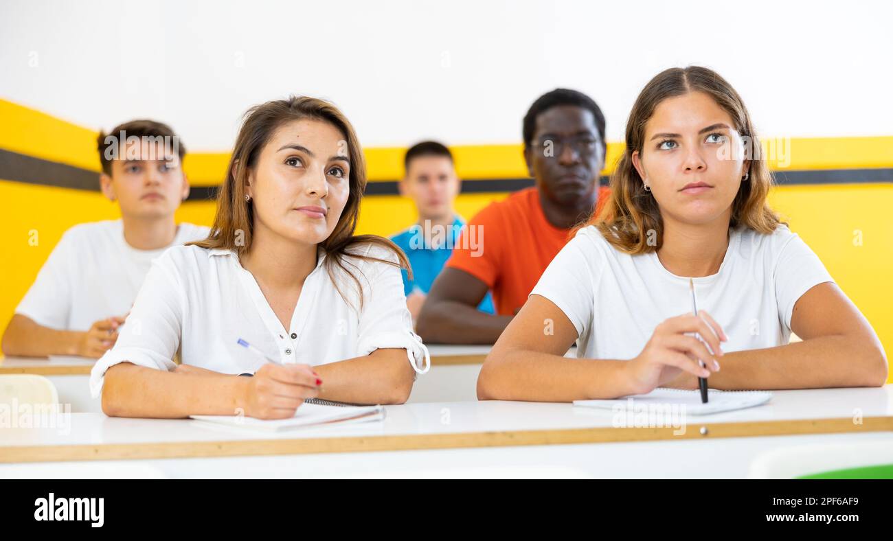 Two woman take a written exam in classroom Stock Photo - Alamy