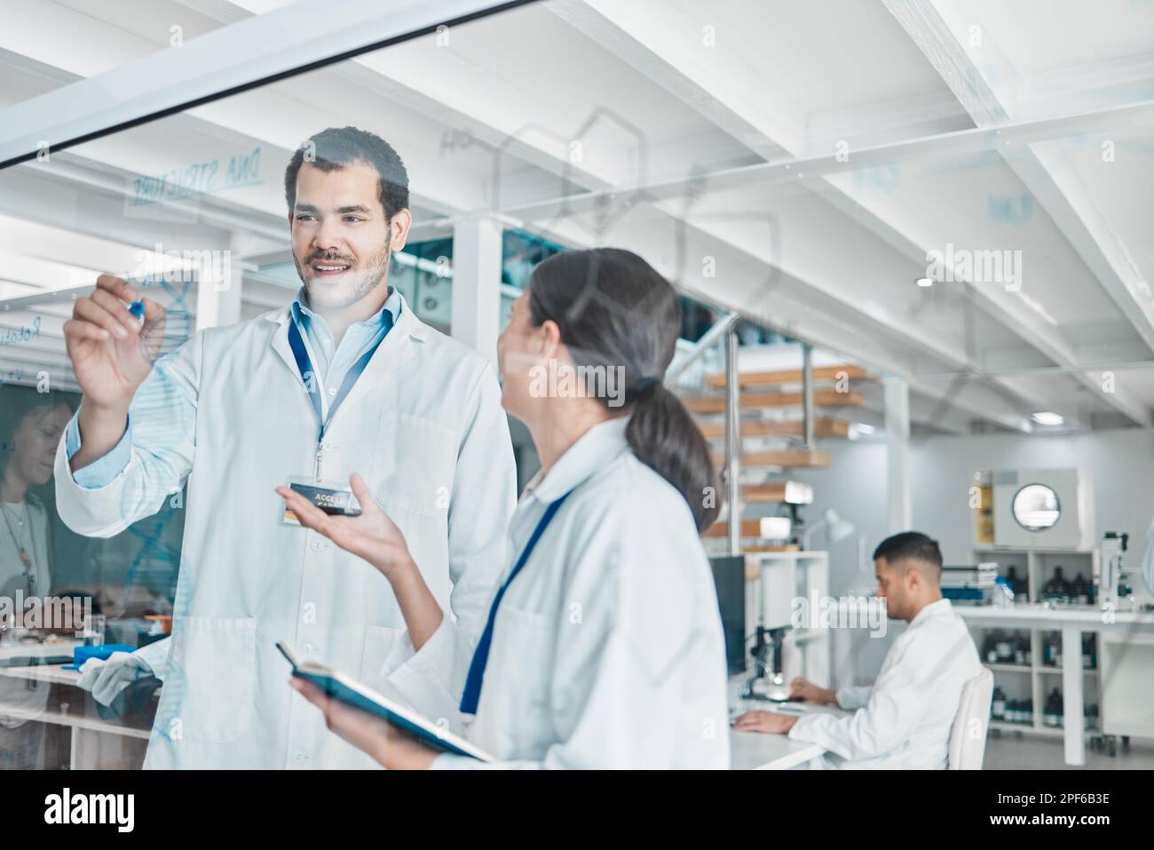 Working on a new and wonderful idea. two young scientists brainstorming ...