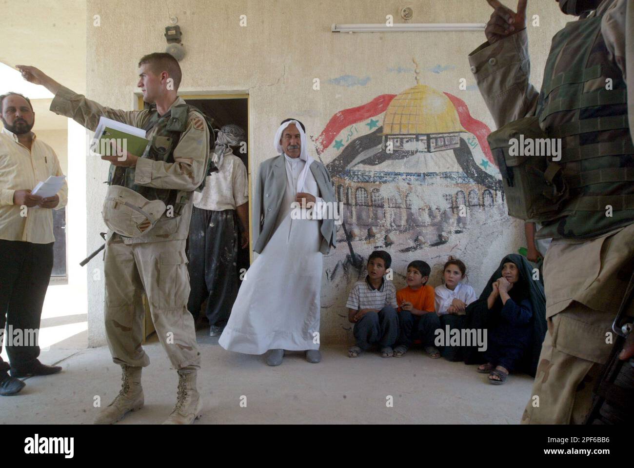 U.S. Army engineers enter a school to make a structural assesment for ...